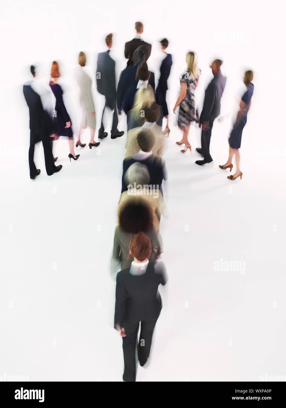 Blurred group of multiethnic businesspeople in arrow formation against ...