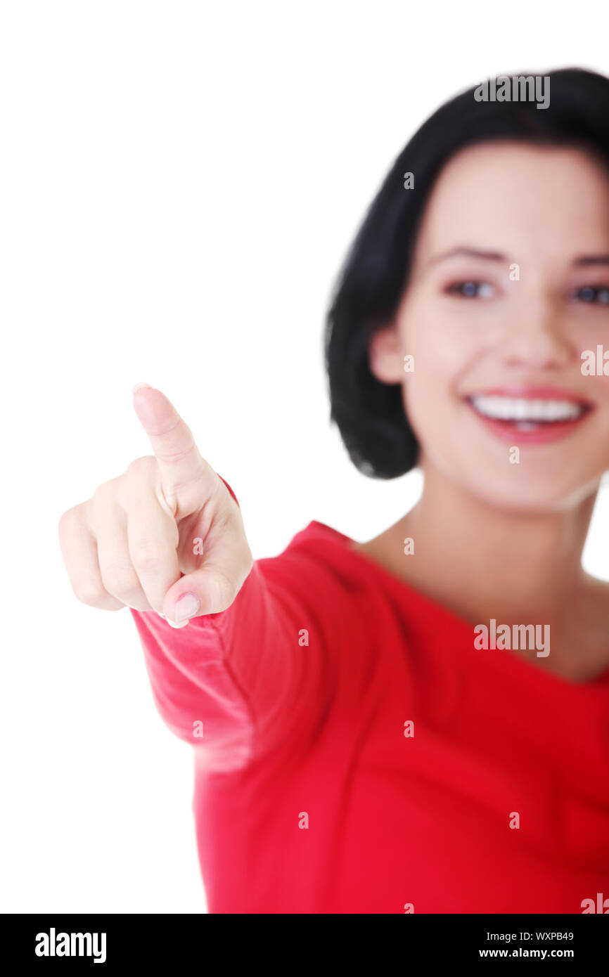 Attractive woman in red tshirt pointing up. Isolated on white Stock ...