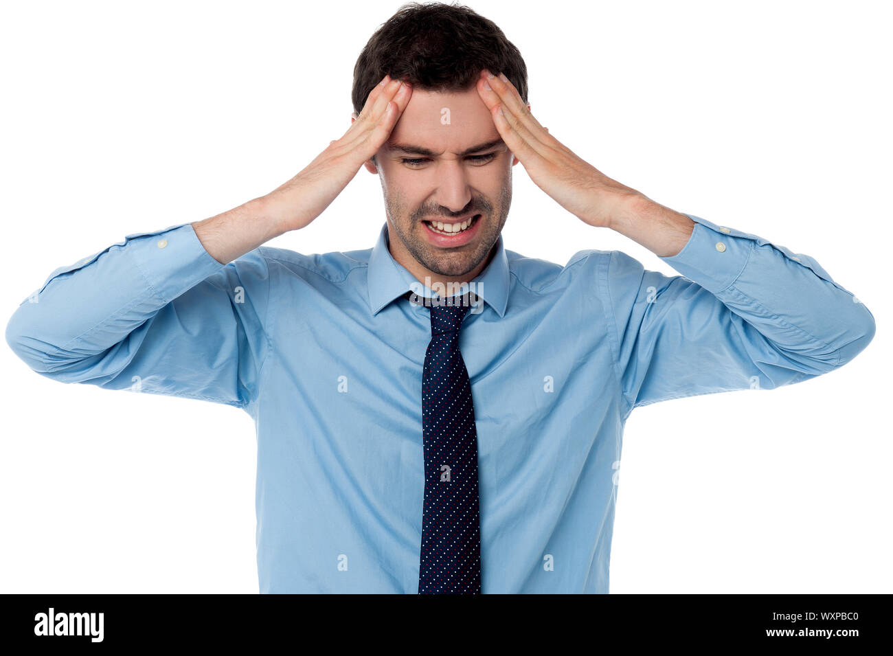 Man suffering from headache wincing Stock Photo - Alamy