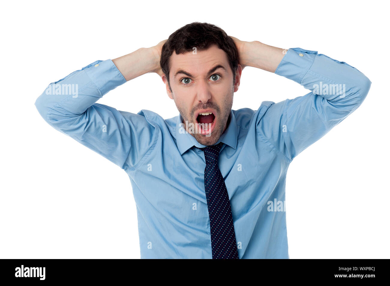 Irritated young businessman isolated over white Stock Photo - Alamy
