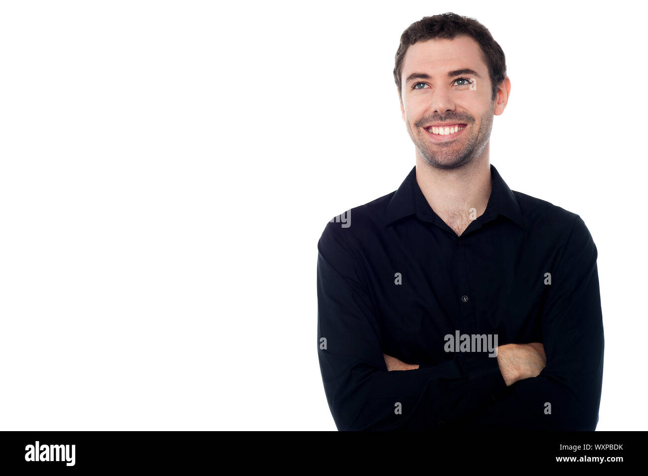 Smiling guy lost in his own world Stock Photo - Alamy