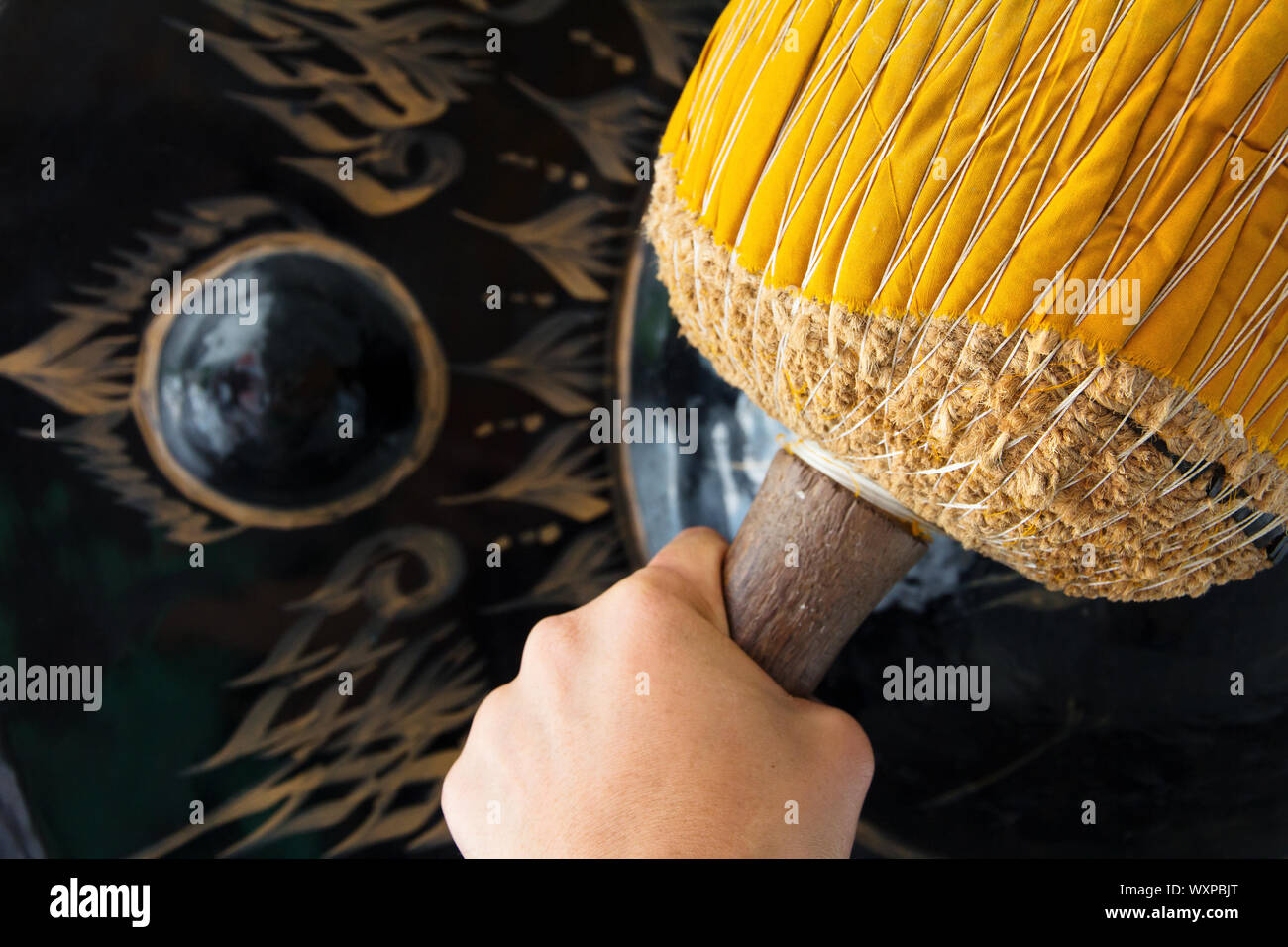 Hand hit big gong in temple Stock Photo - Alamy