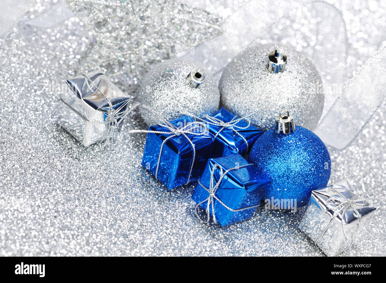 Christmas card with gifts and decoration on shiny silver background ...