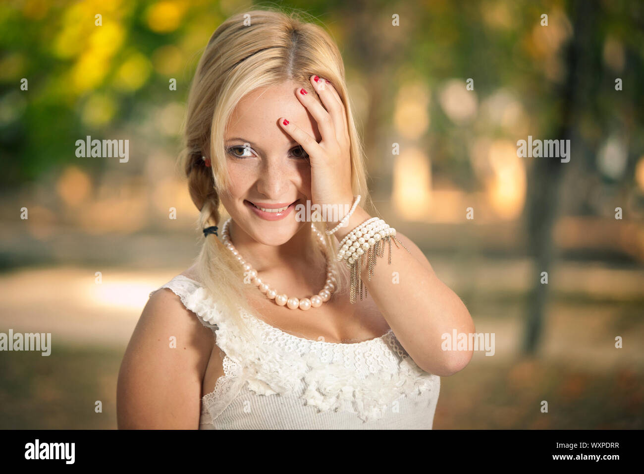 Outdoor portrait of a beautiful young girl smiling Stock Photo - Alamy