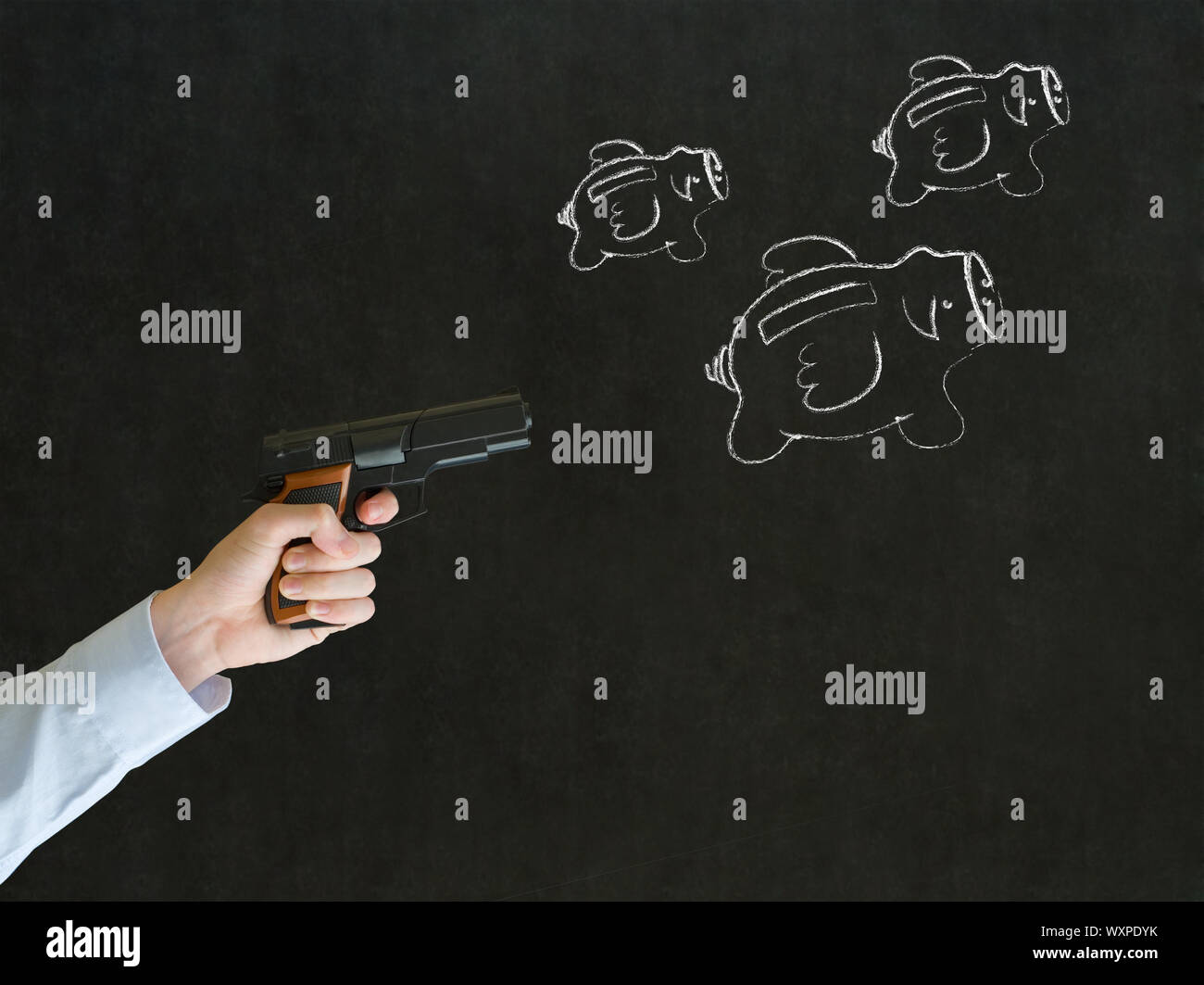 Businessman shooting gun at flying money piggy banks in chalk on ...