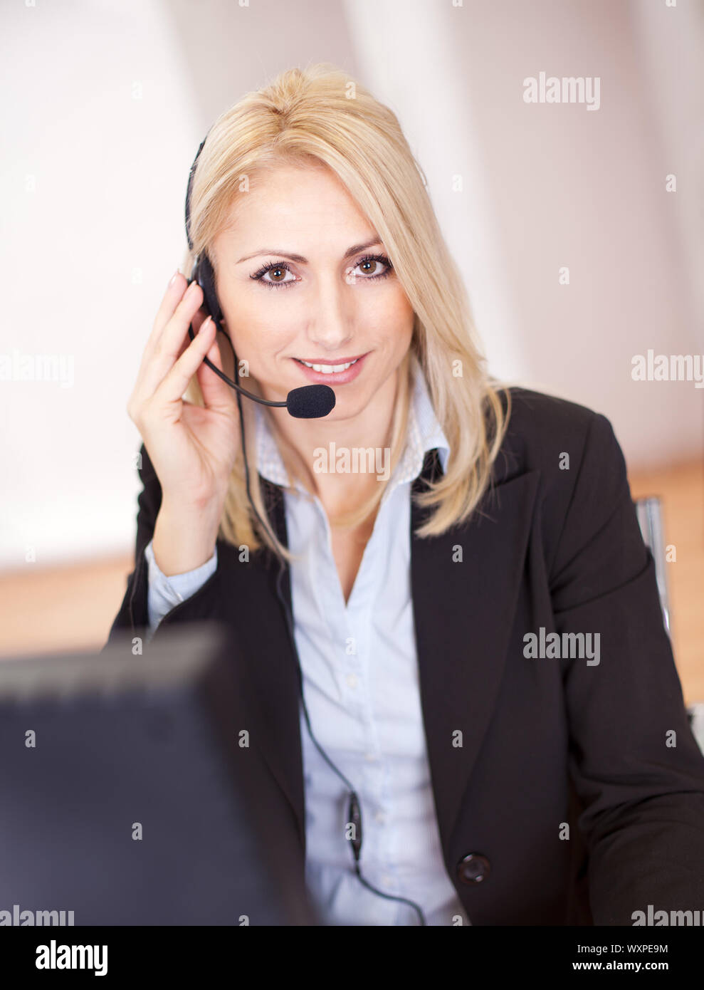 Beautiful call center operator talking over the phone in the office ...