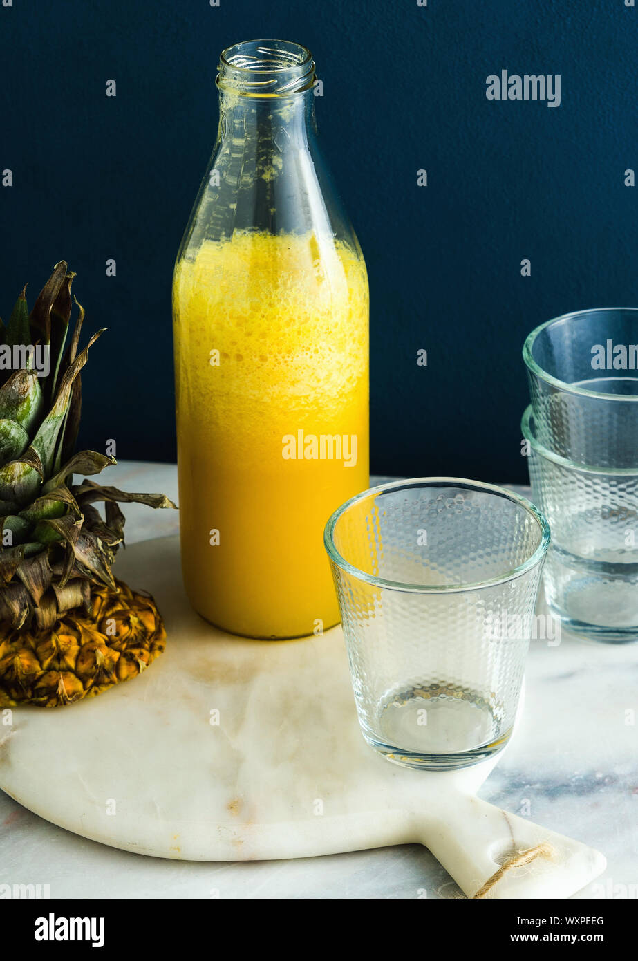 Fresh pineapple juice on a table in a bottle and glasses Stock Photo ...