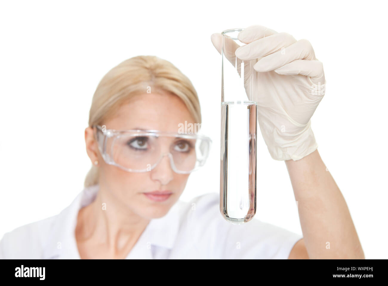 Researcher looking into liquid inside the tube in laboratory Stock ...