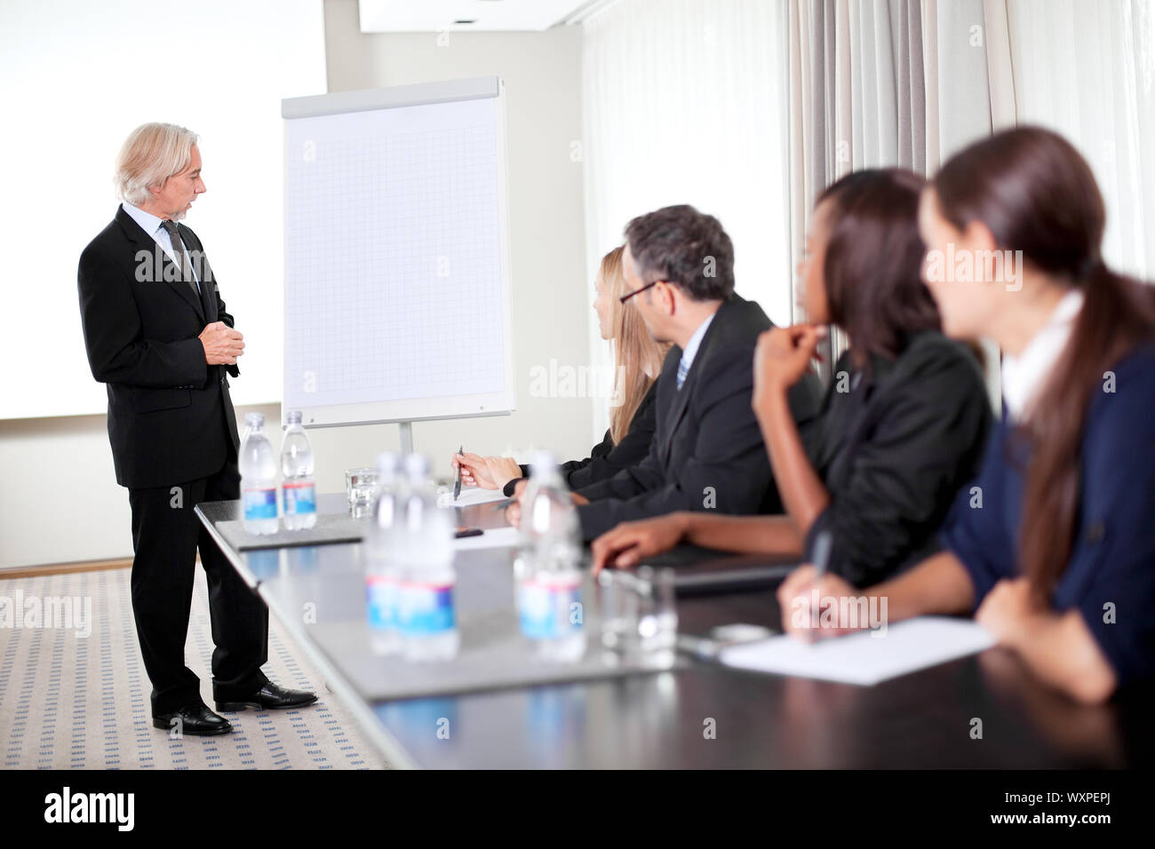 Successful young male business executive heading a business conference ...