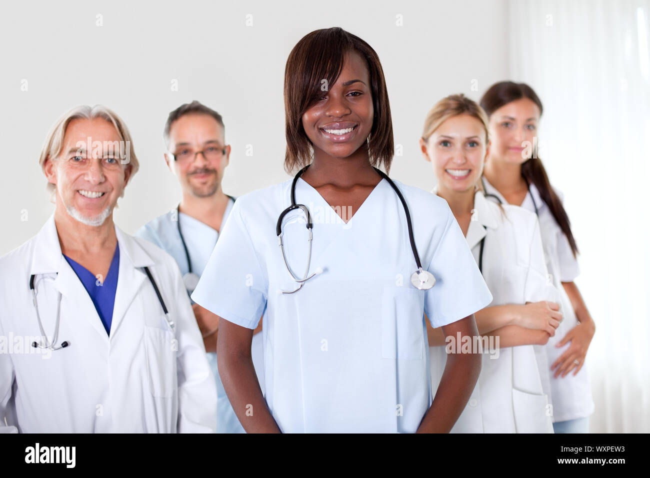 Friendly group of successful happy multi-ethnic doctors smiling at the ...