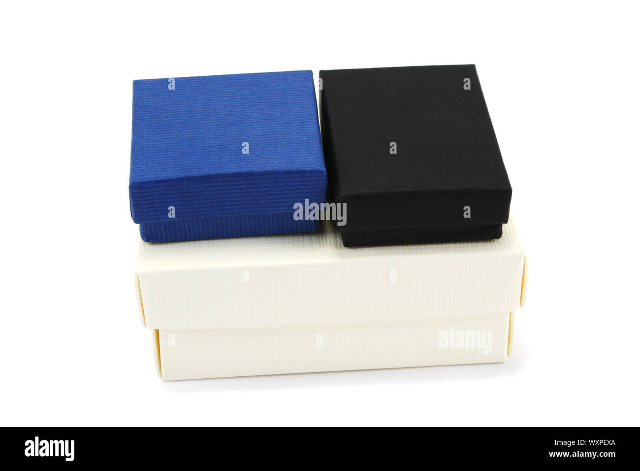 two small gift boxes on a larger cream gift box Stock Photo - Alamy