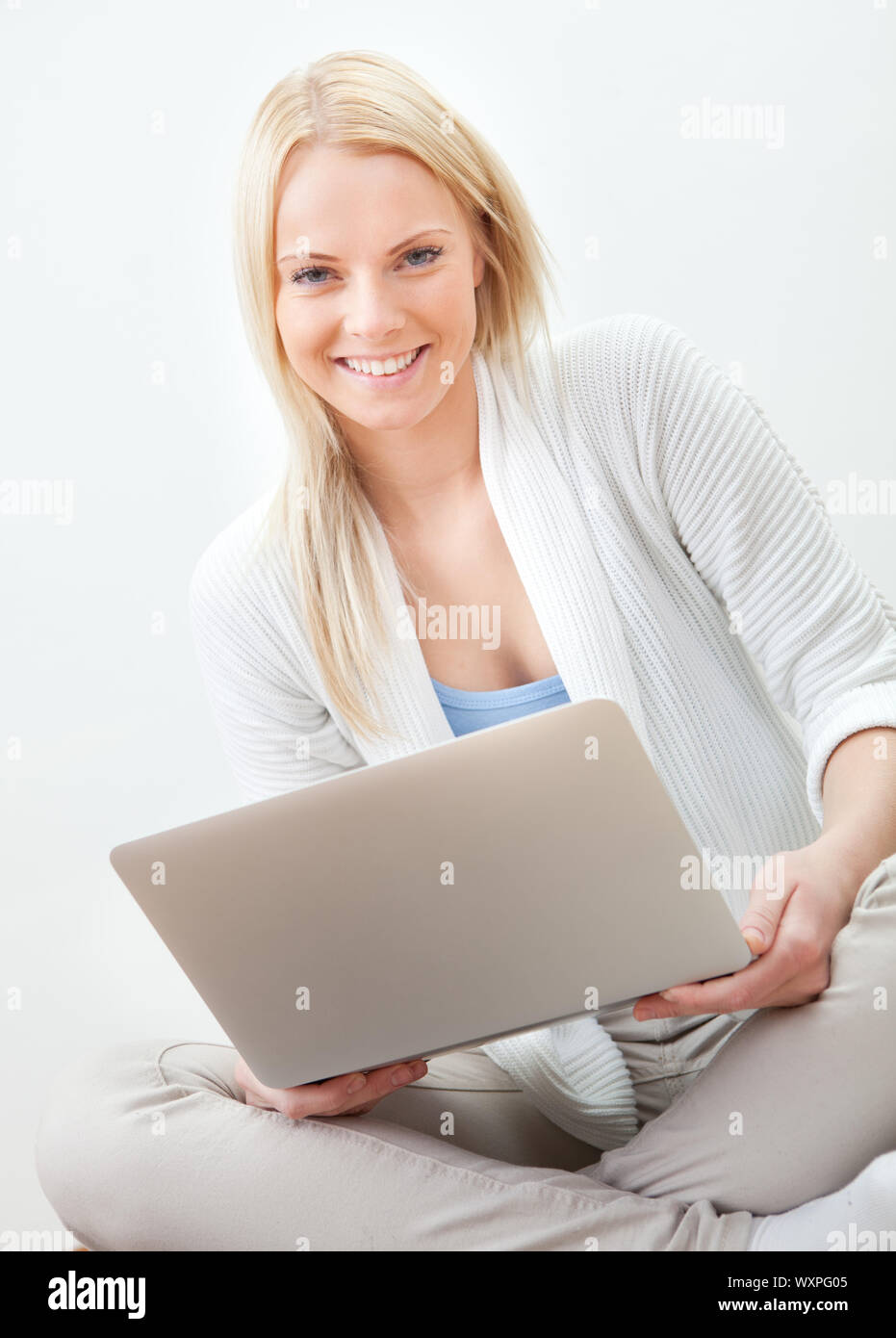 Beautiful woman working on computer sitting on floor Stock Photo - Alamy