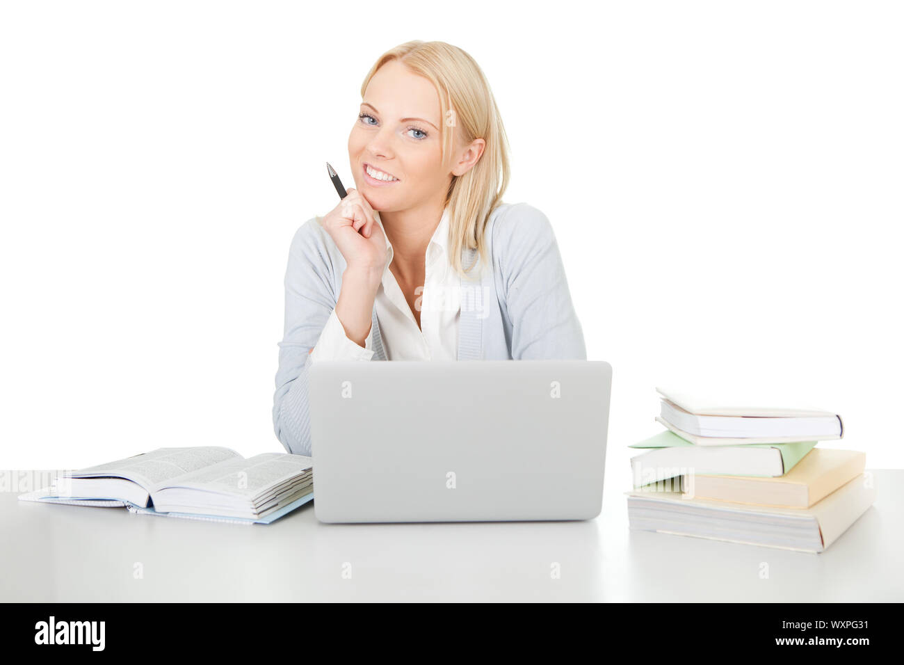 Beautiful student girl studying with laptop at the desk. Isolated on ...