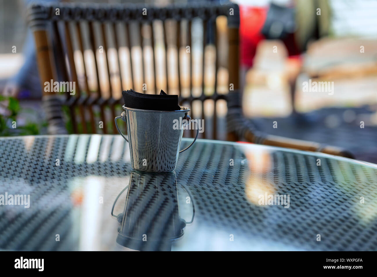 Bucket with napkins on a cafe table Stock Photo - Alamy