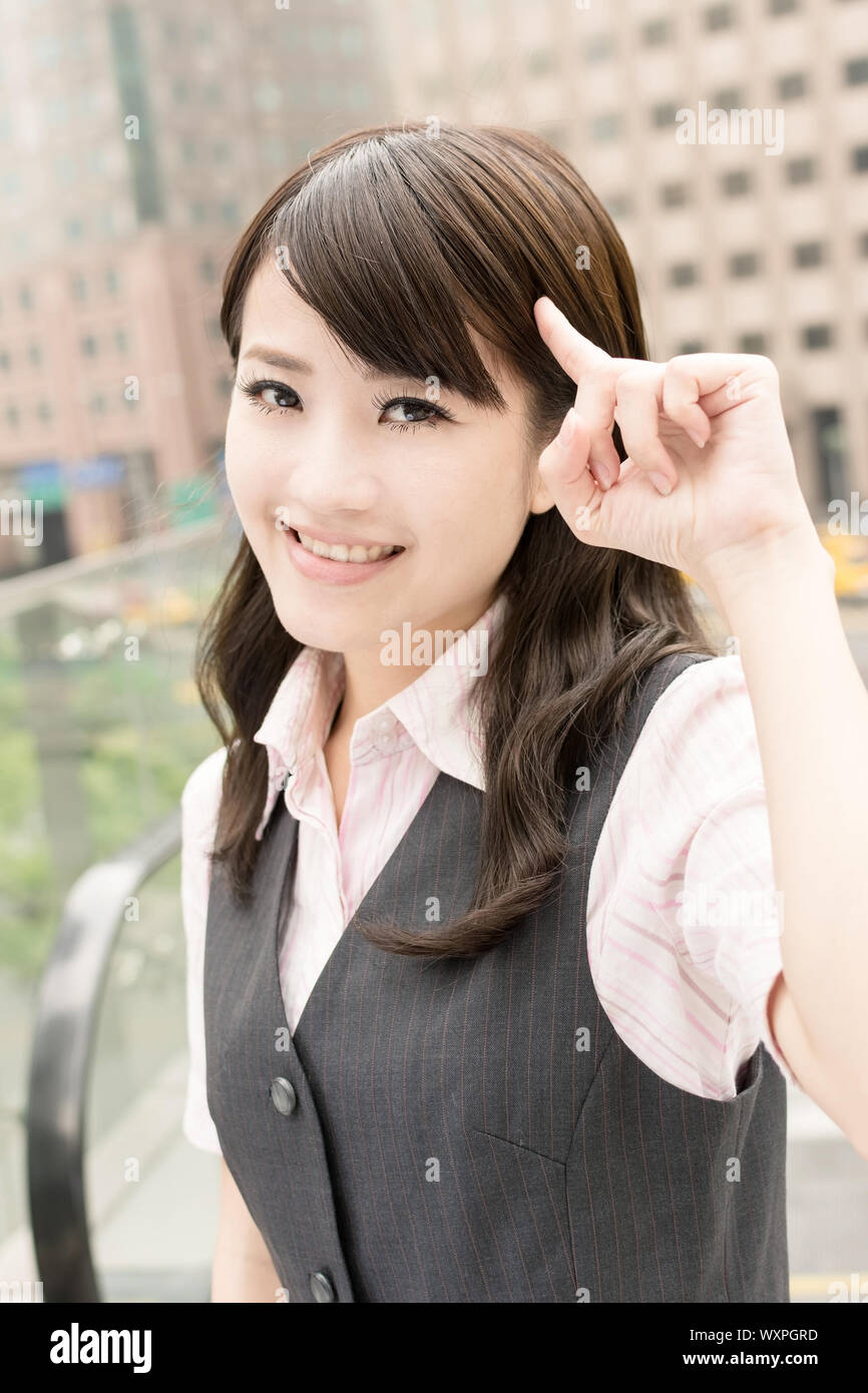 Business woman put finger on head, closeup portrait with idea concept ...