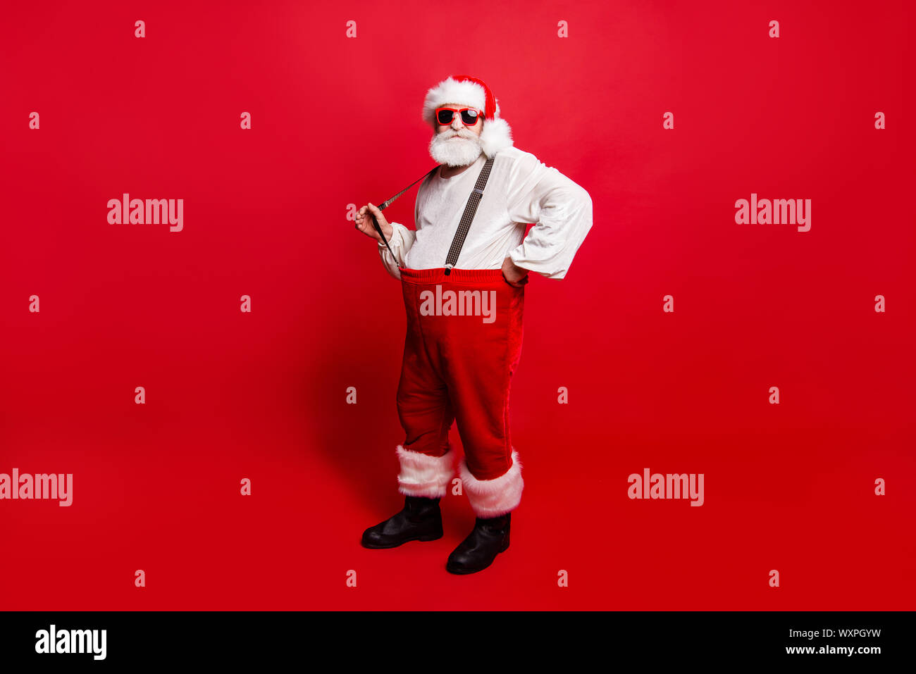 Full length body size of nice calm peaceful Santa pulling suspender ...
