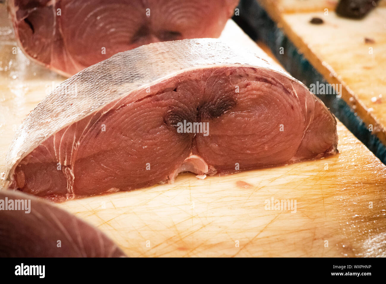 big raw fish slice on table in fish market closeup Stock Photo - Alamy
