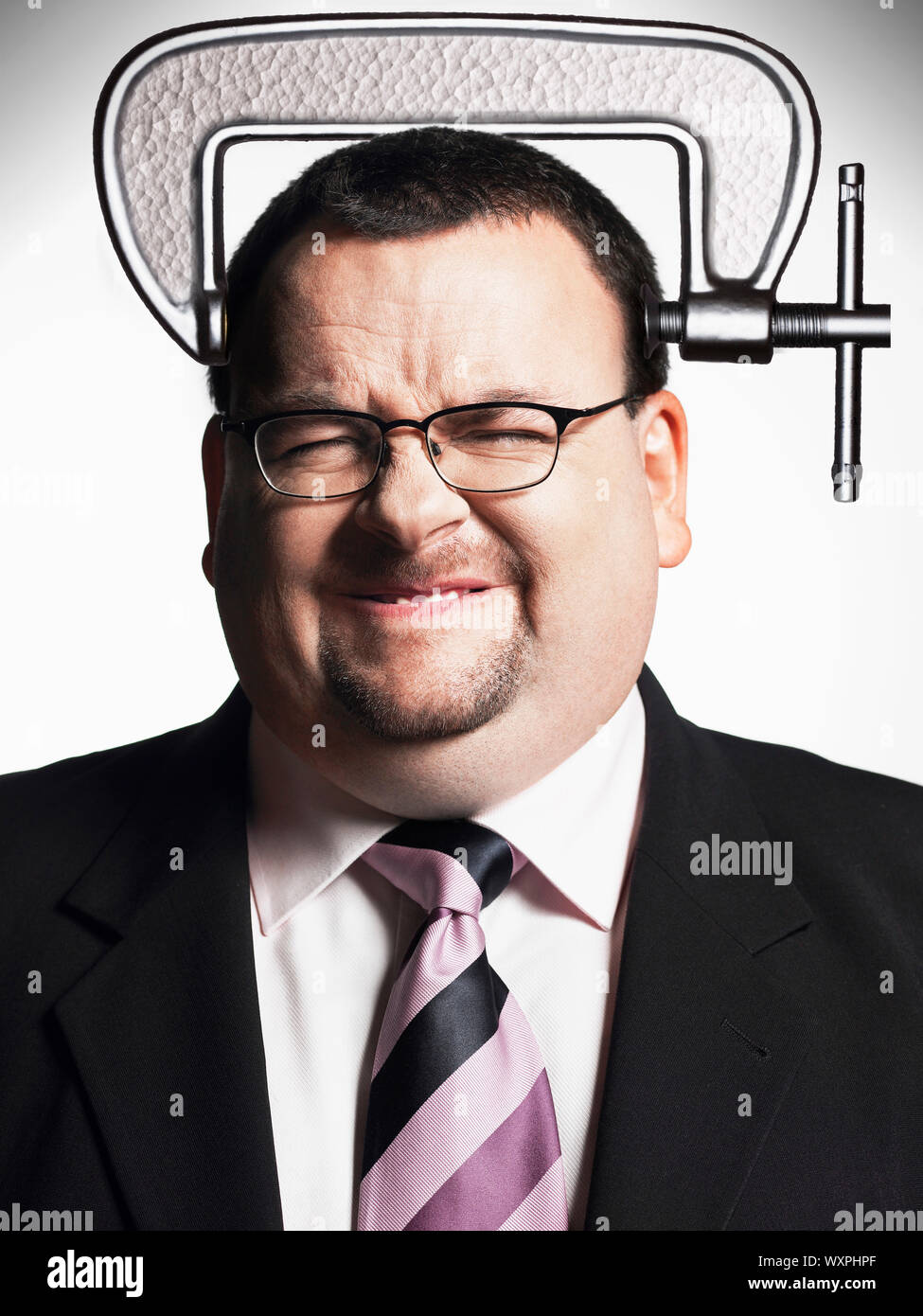 Businessman with Head in Vice Stock Photo - Alamy