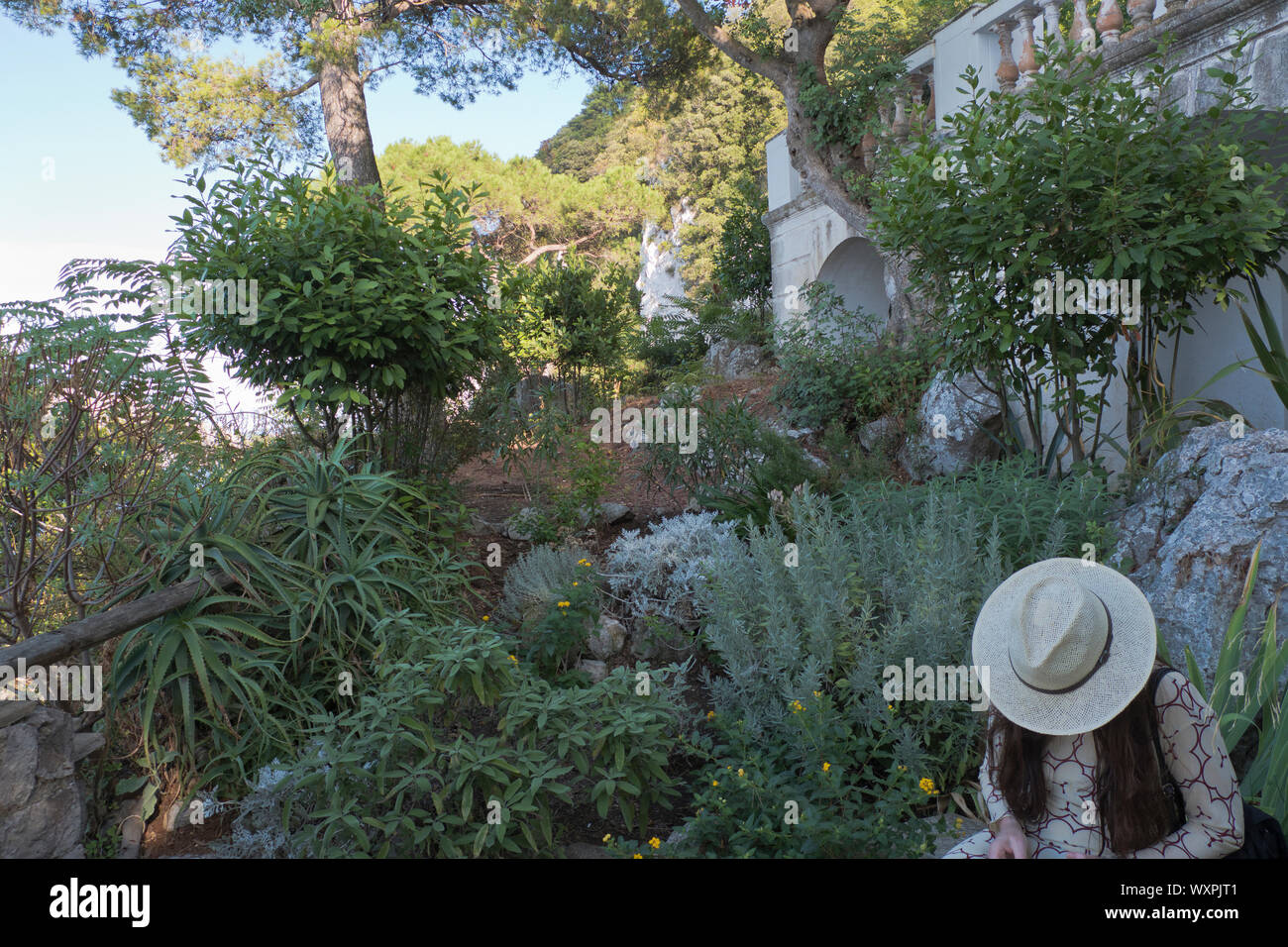 Woman sitting in the gardens of Villa Lysis home of Jacques Fersen in ...