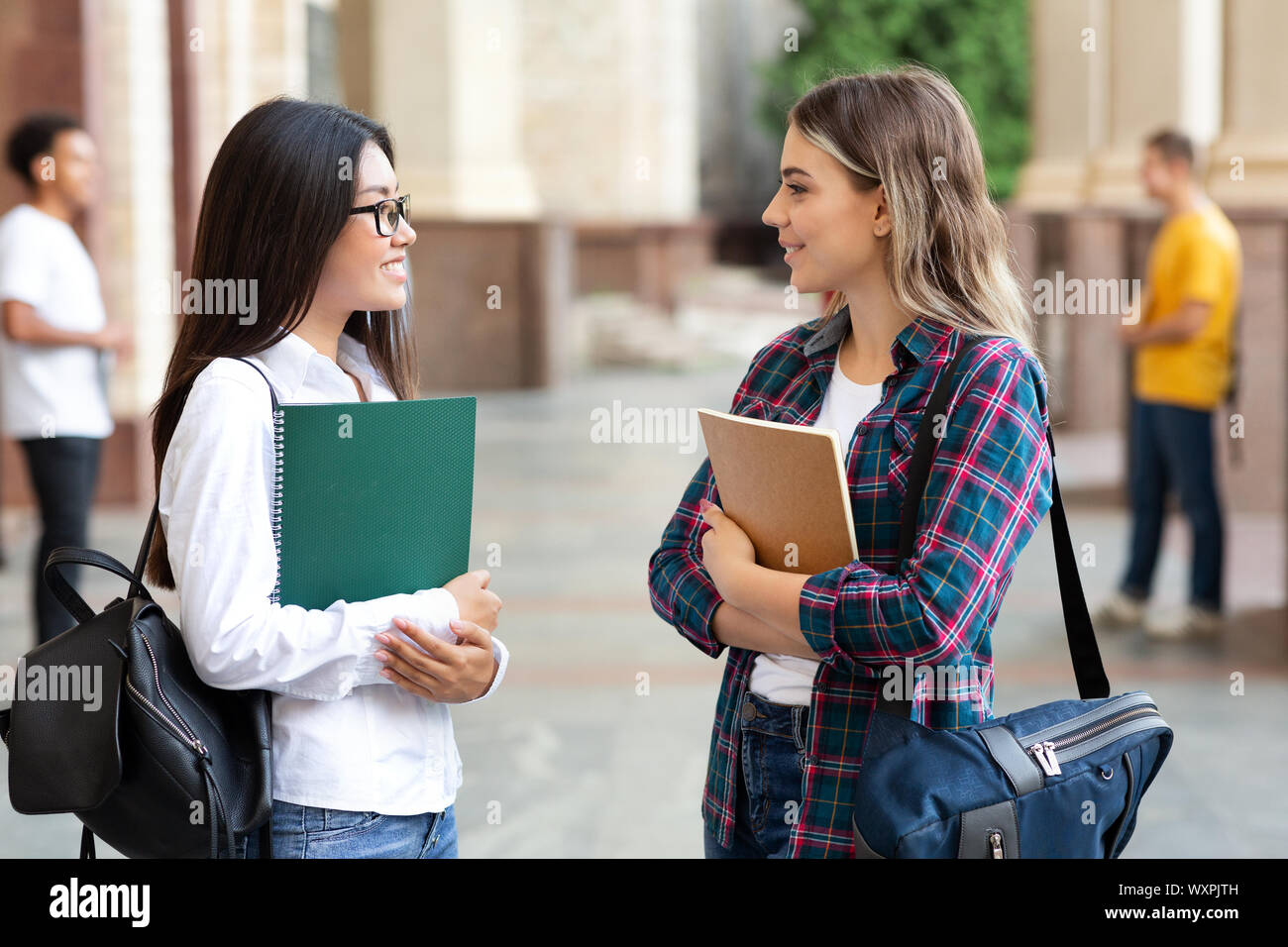 Student girls resting between classes and talking outdoors Stock Photo ...