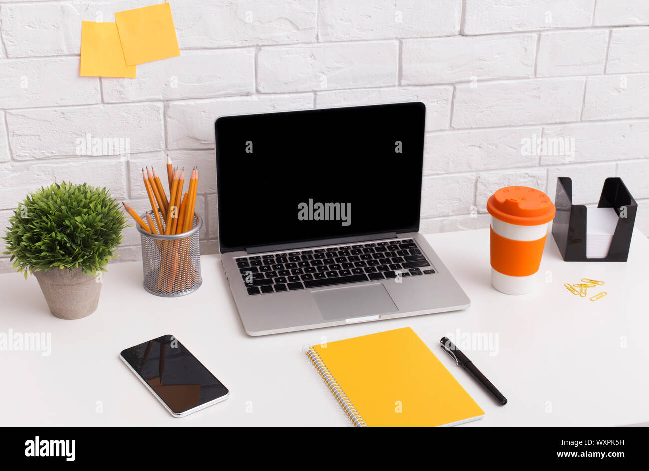 Orange style workplace with laptop on white office table Stock Photo ...