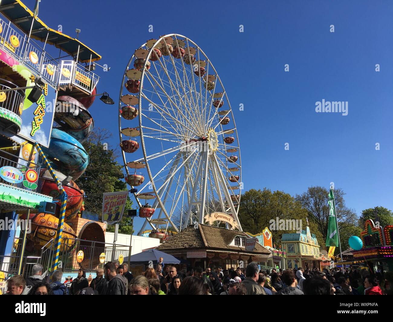 BERLIN - JUNE 3, 2017: Ferris Wheel, Fun House and Refreshment Stands ...