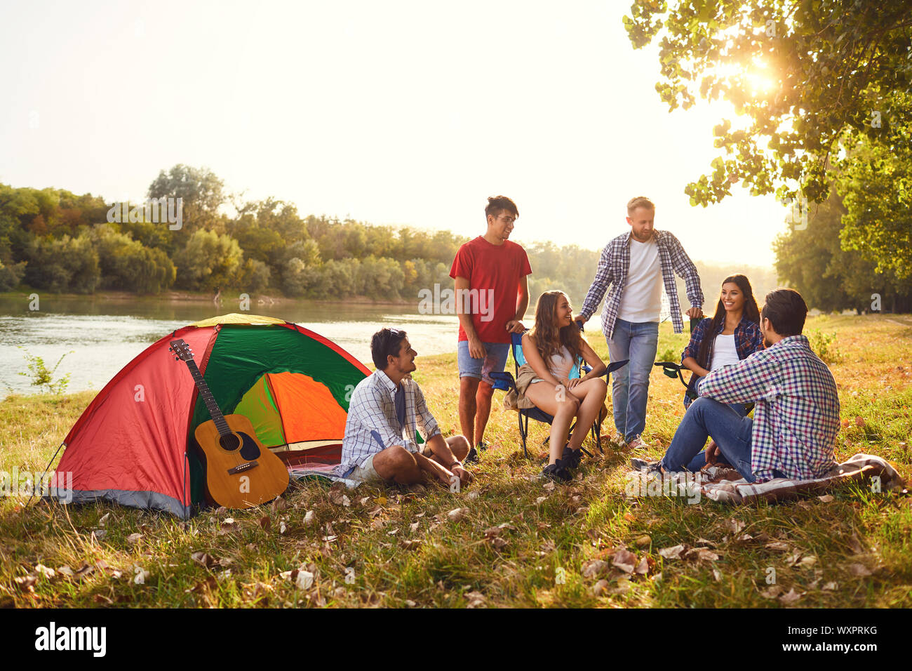 A group of friends have a picnic in a forest in autumn Stock Photo - Alamy