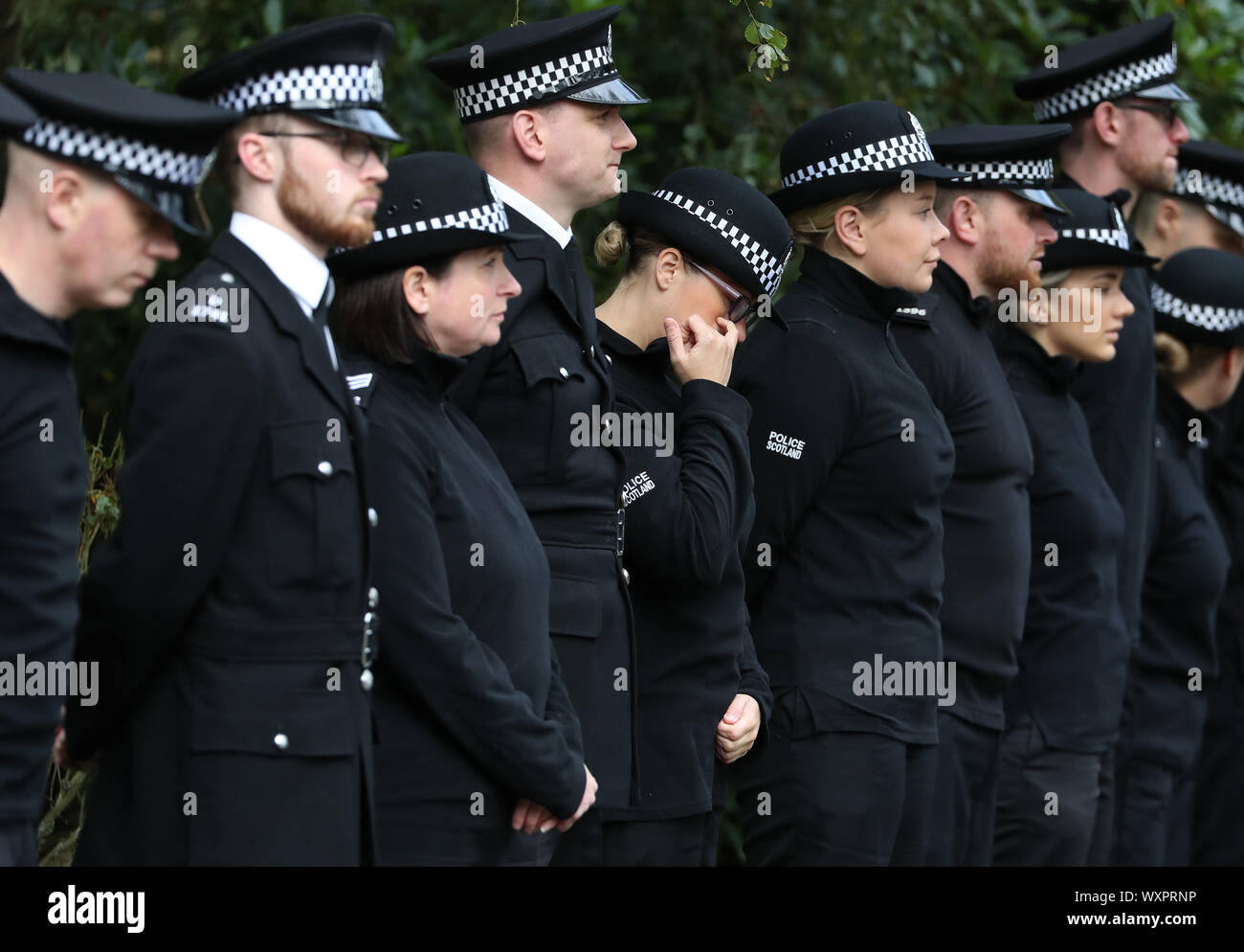 Police officers and other emergency services form a guard of honour, as ...