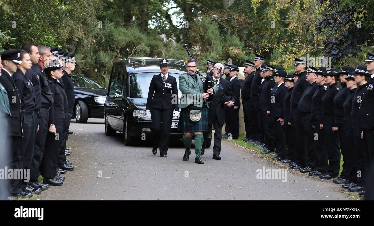 Police officers and other emergency services form a guard of honour, as ...