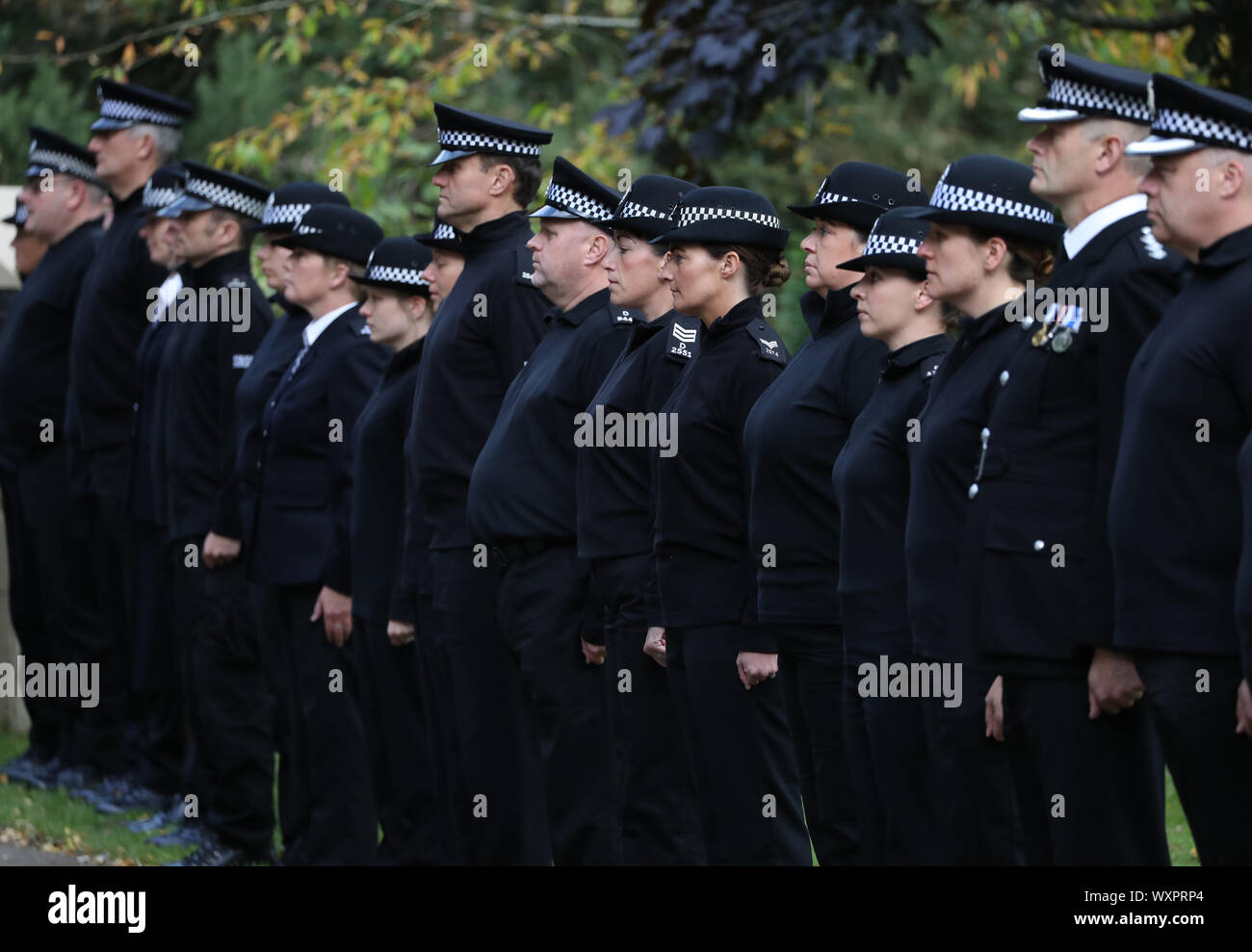 Police officers and other emergency services form a guard of honour, as ...