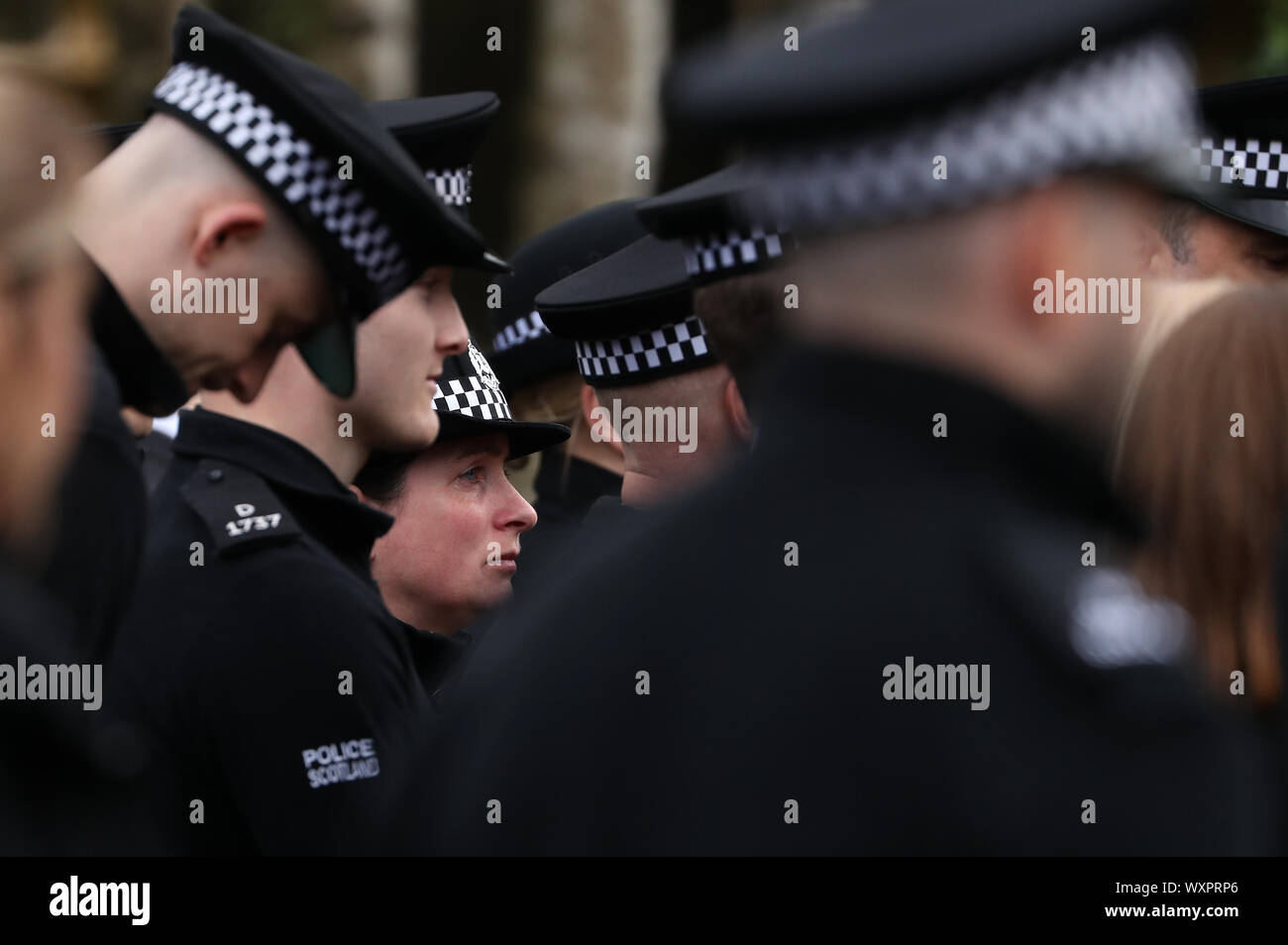 Police officers and other emergency services form a guard of honour, as ...