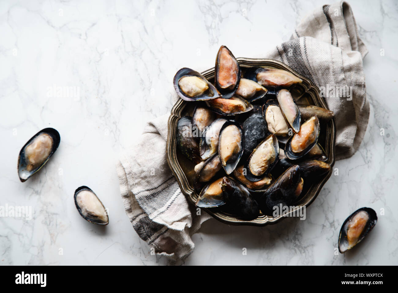 Top view with frozen mussels on white marble background Stock Photo - Alamy