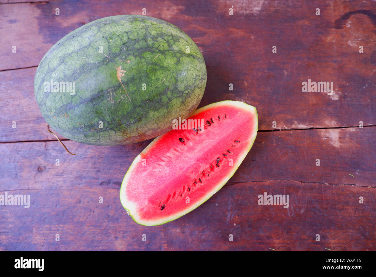 Fresh chopped watermelon on a black wood floor Stock Photo - Alamy