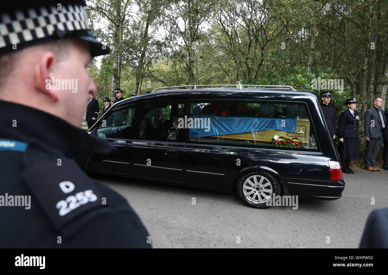 Police officers and other emergency services form a guard of honour, as ...