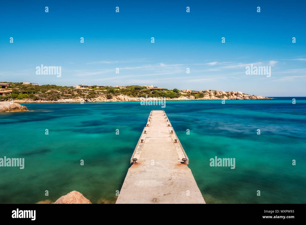 Long exposure image of an old jetty over a turquoise mediterranean sea ...