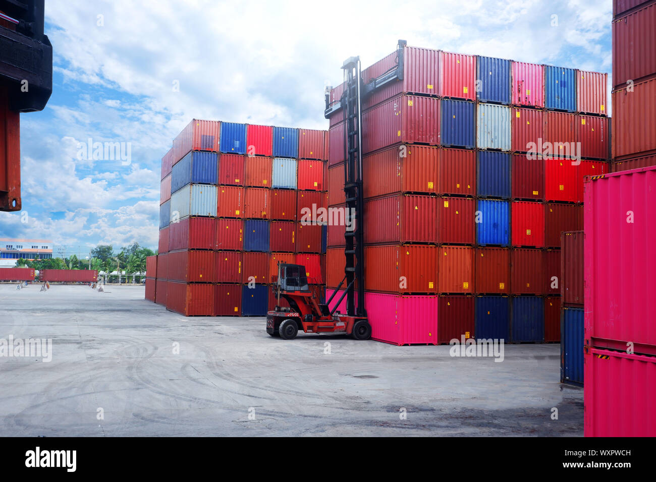 Crane lifting up container in warehouse Stock Photo - Alamy
