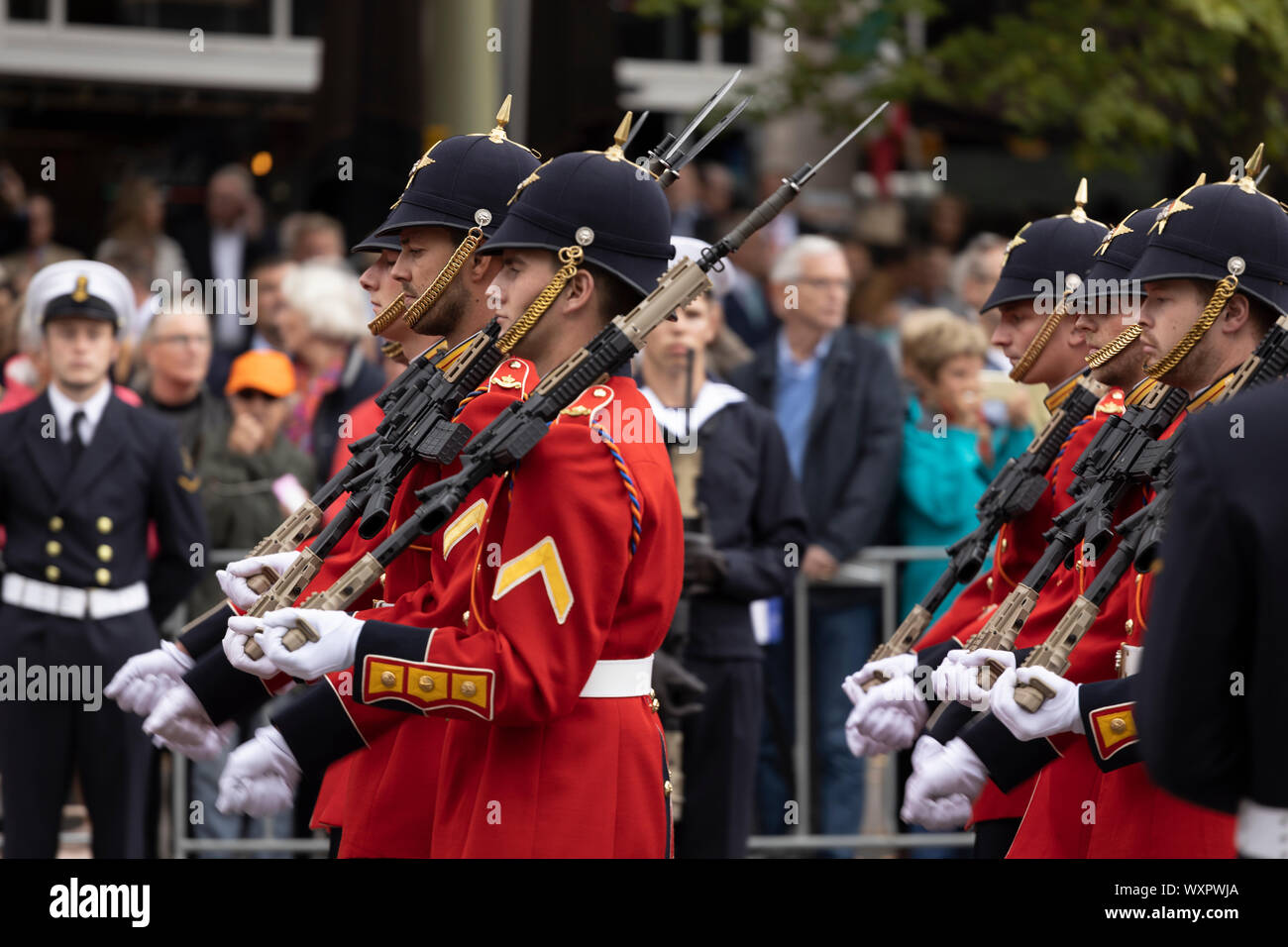 Military parade in traditional uniforms before the Dutch king and queen ...