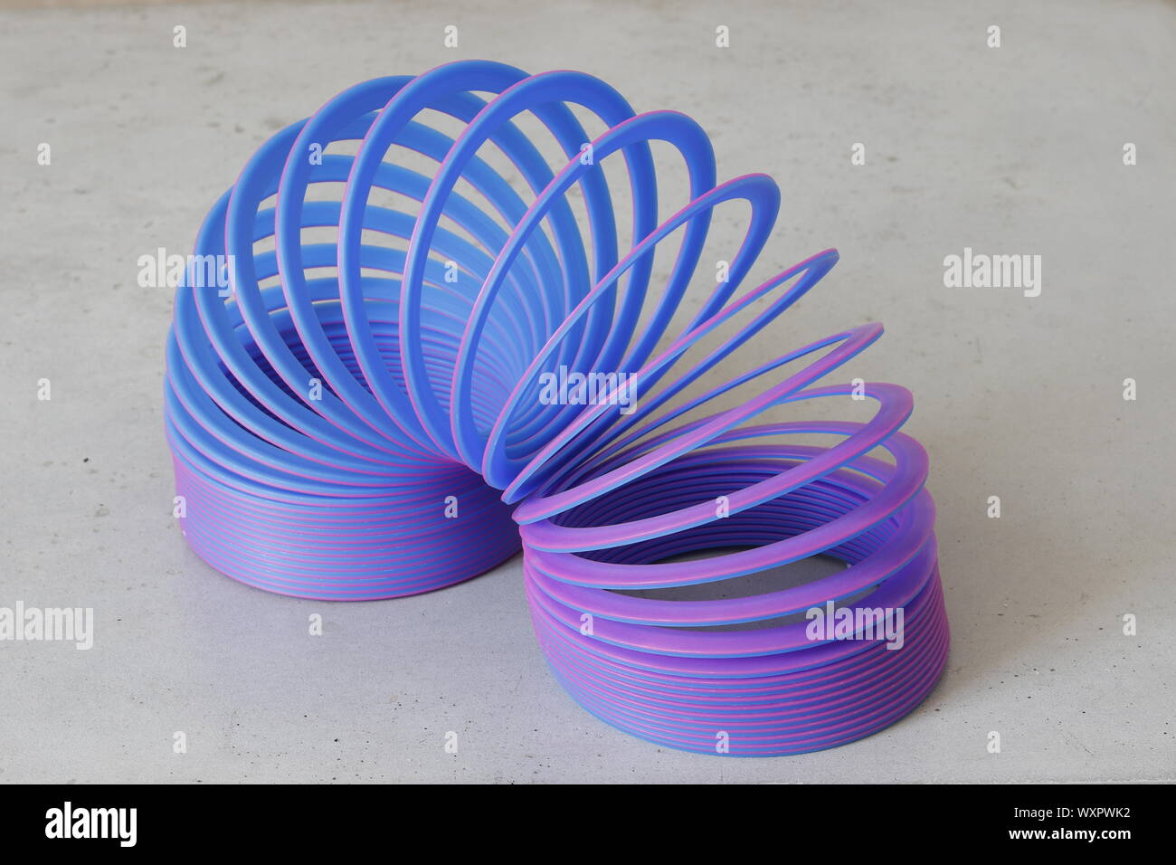 Bern, may 2019: The spiral, a 90s toy for kids. Blue and violet spiral ...