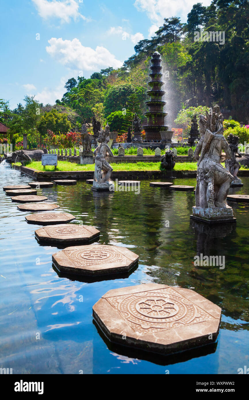 Ancient water palace Tirta Gangga with fountains, natural pools, path ...