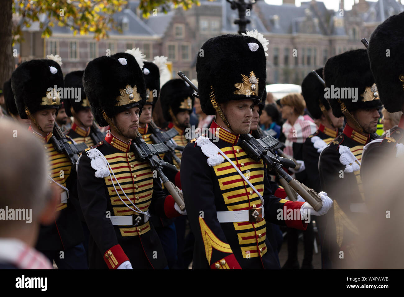 Military parade in traditional uniforms before the Dutch king and queen ...