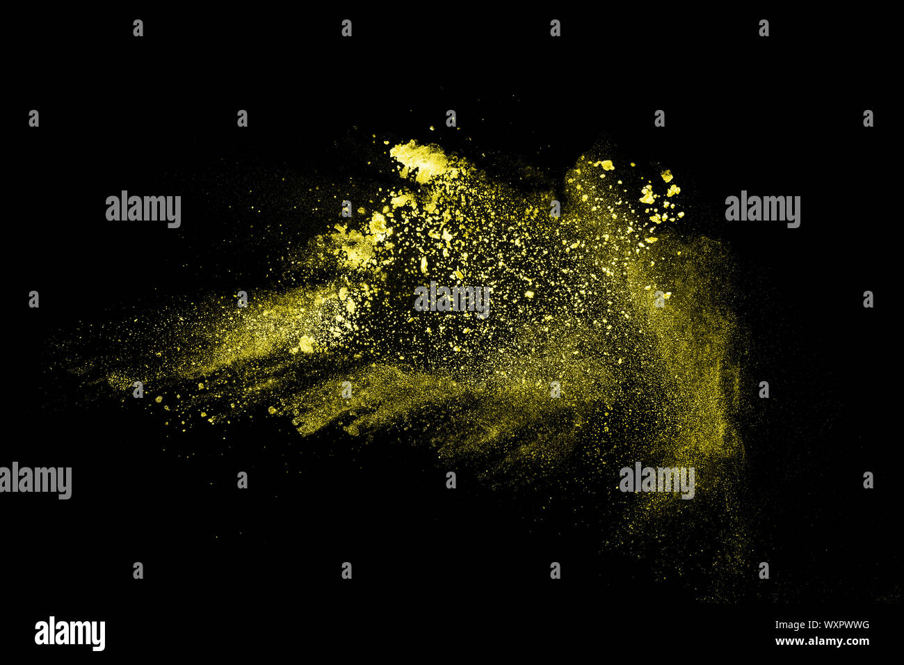 Yellow dust particles explosion on black background. Yellow powder ...