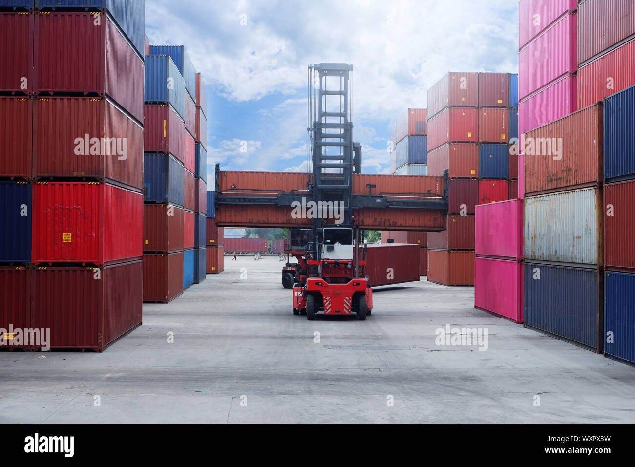 Crane lifter handling container box loading to depot Stock Photo - Alamy