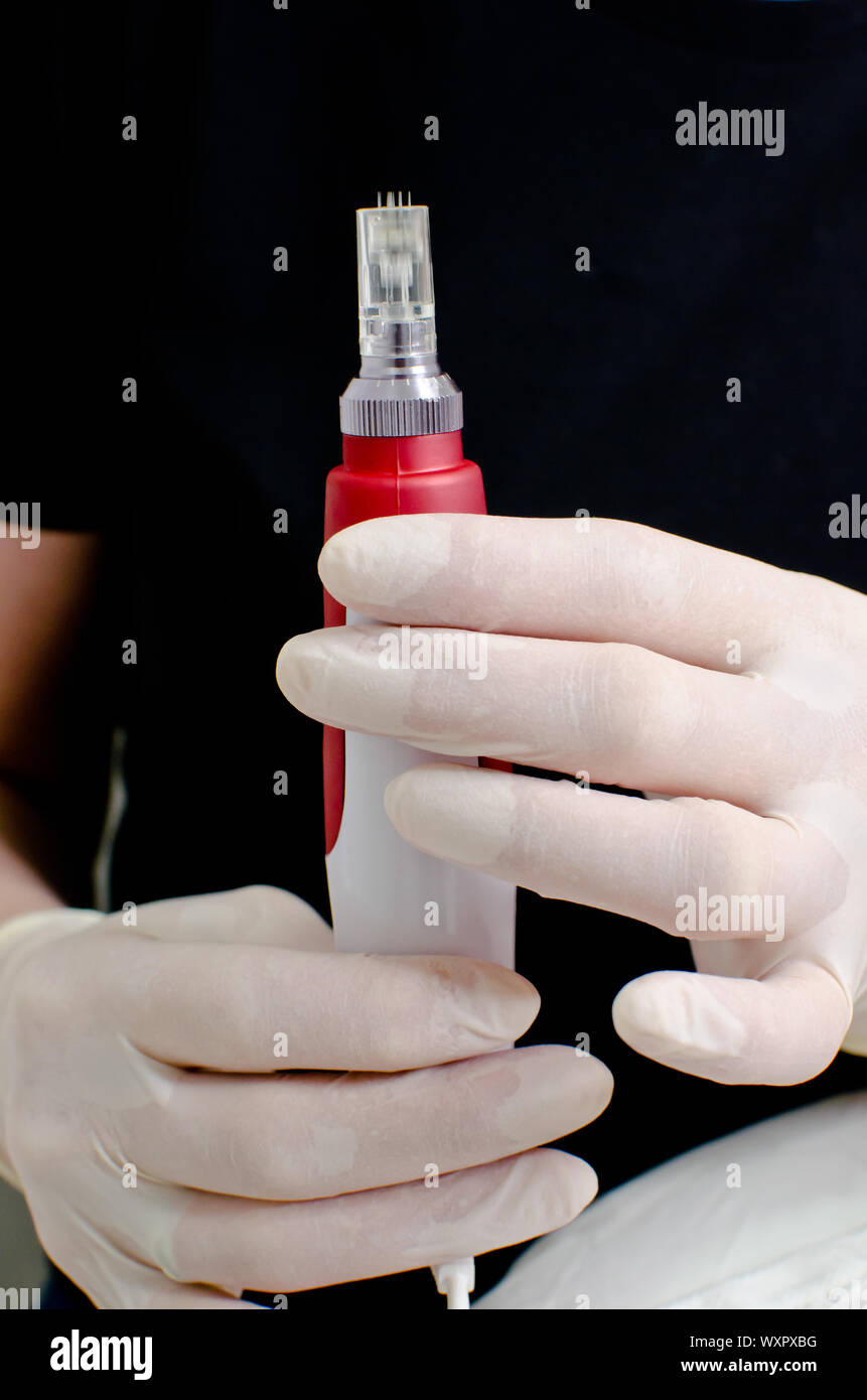 beautician in white gloves holding dermis stamp electric pen,dermapen ...
