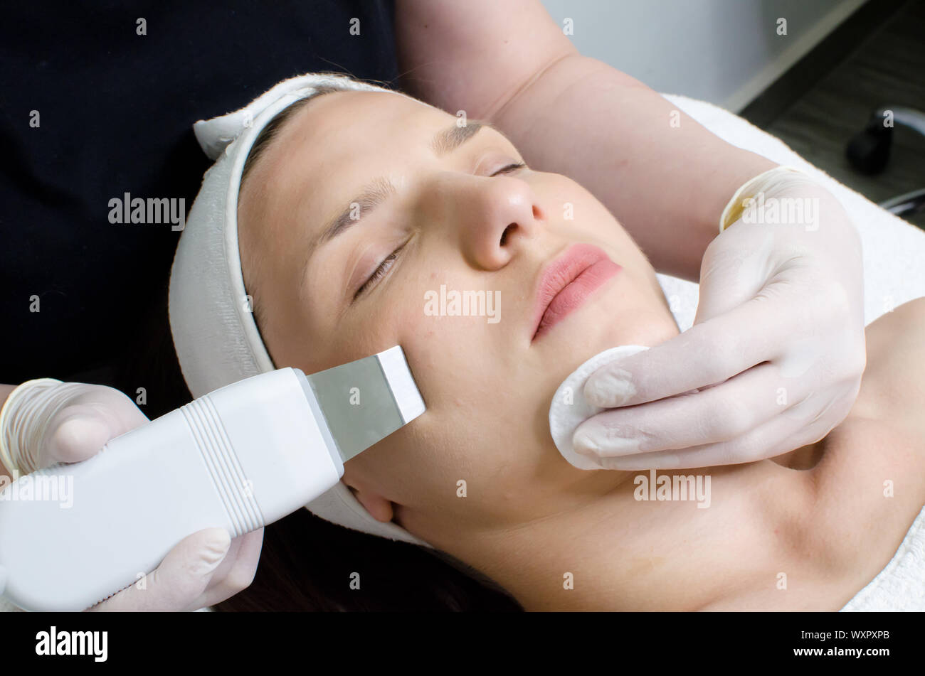 Beautiful woman receiving ultrasonic facial exfoliation procedure of ...