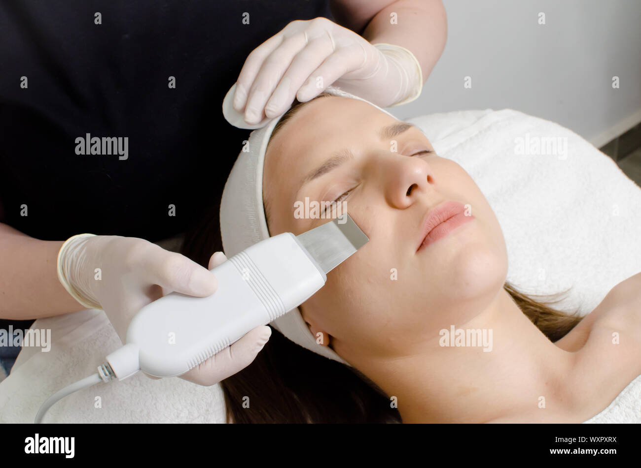 Beautiful woman receiving ultrasonic facial exfoliation procedure of ...