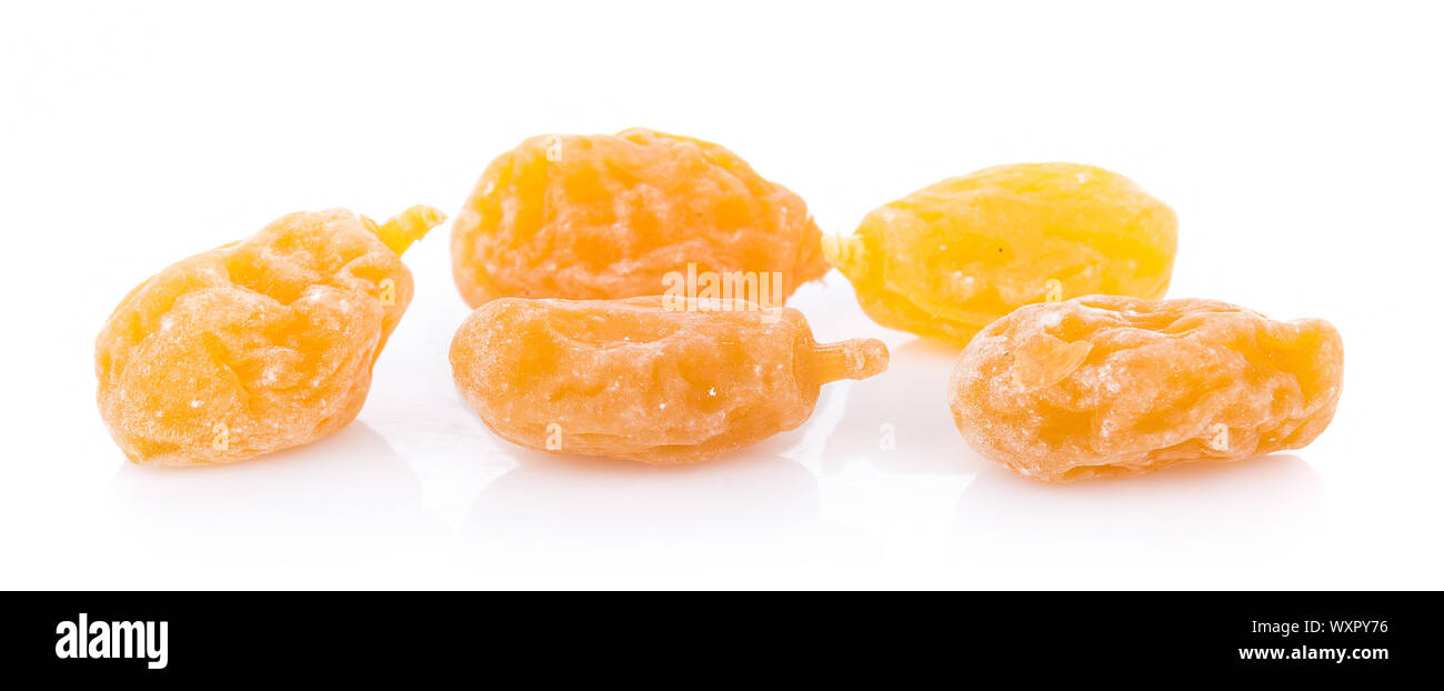 Dry yellow plums on white background Stock Photo - Alamy