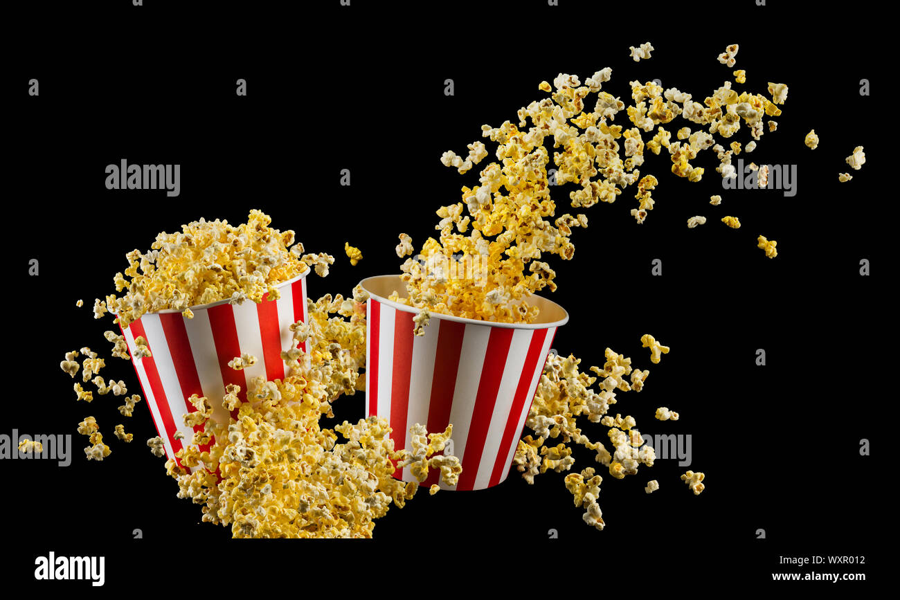 Set of paper striped buckets with popcorn isolated on black background ...
