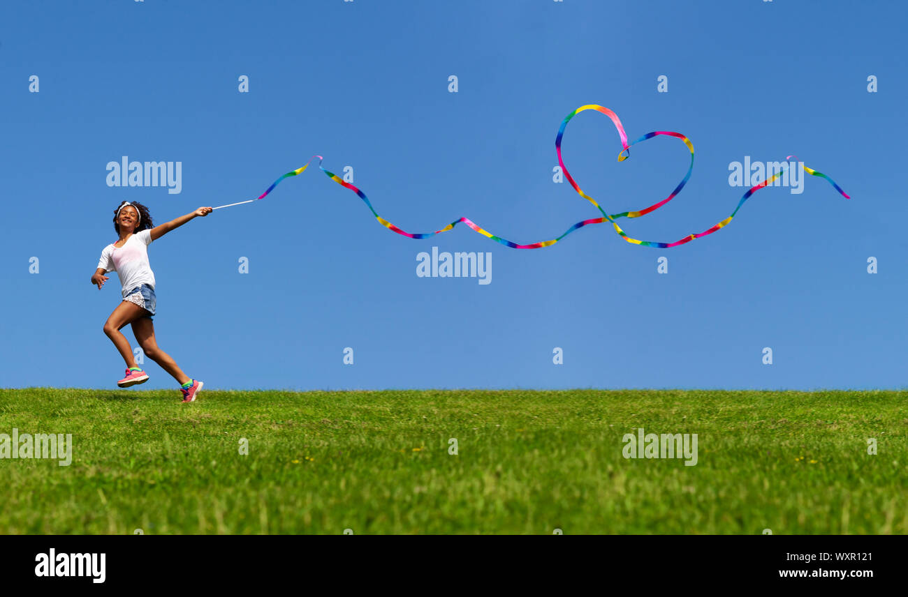 Cute young girl run with ribbon in heart shape Stock Photo - Alamy