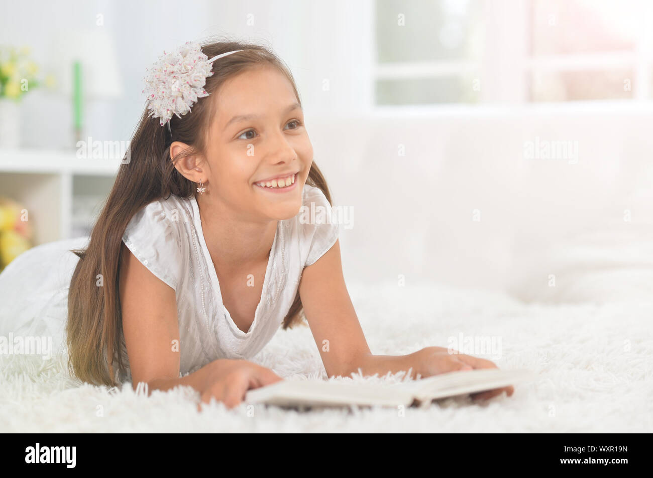 little cute girl reading book at home Stock Photo - Alamy