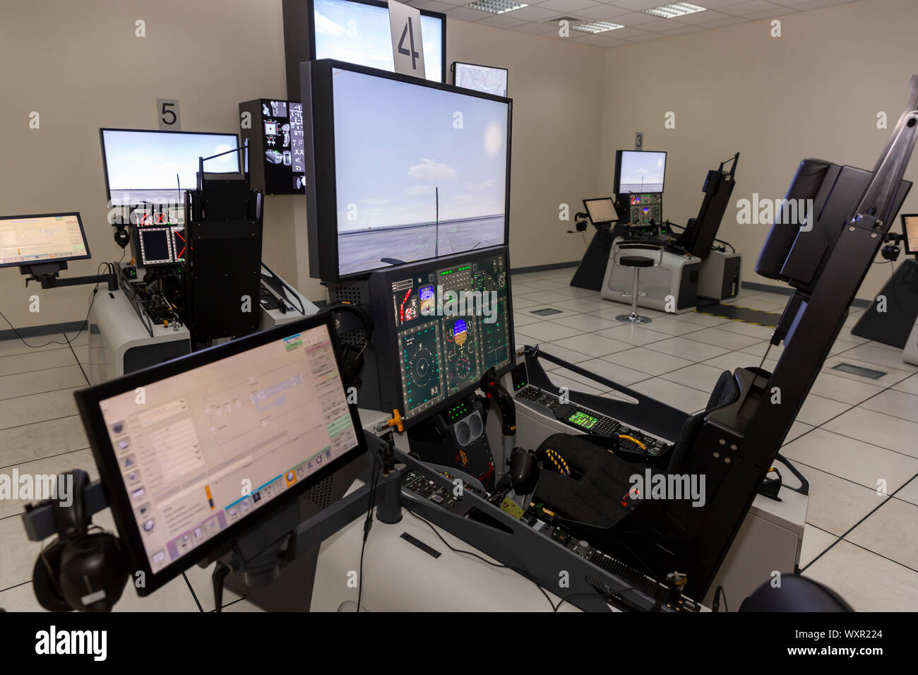 Fighter aircraft simulator training room. A flight simulator is a ...
